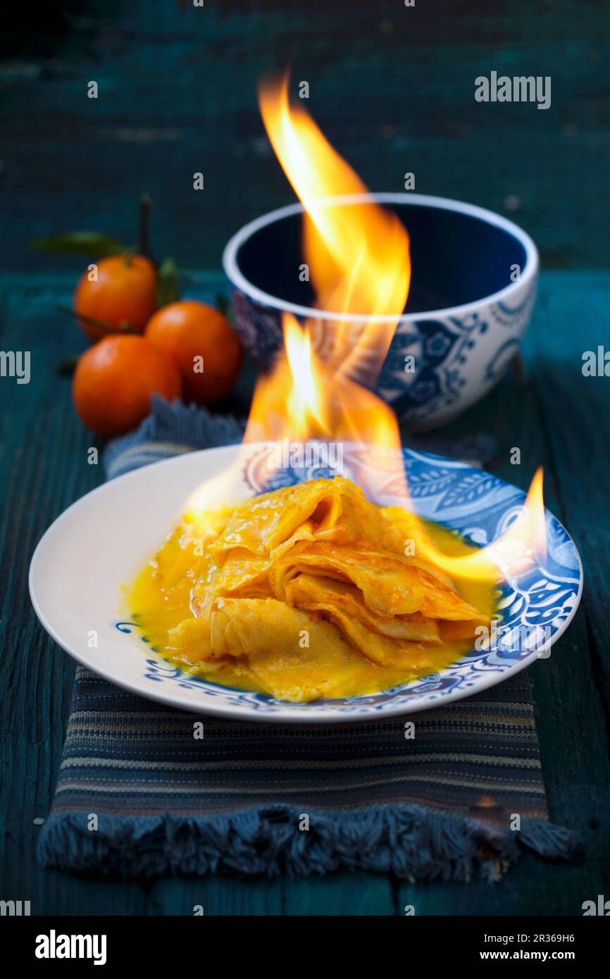 Crêpe Suzette being flambéed with orange syrup and orange liqueur Stock ...