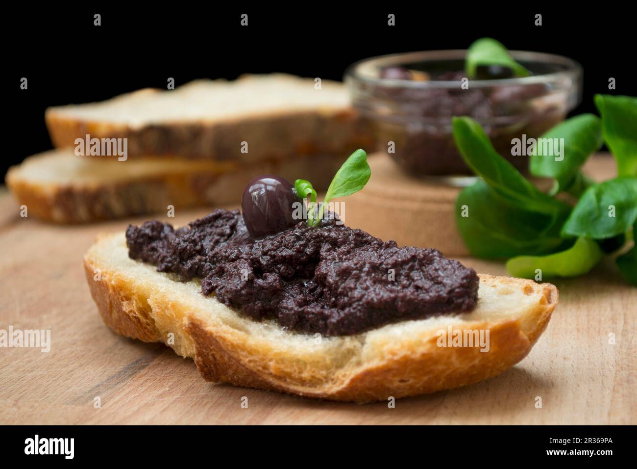 Olive paste on a slice of bread Stock Photo - Alamy
