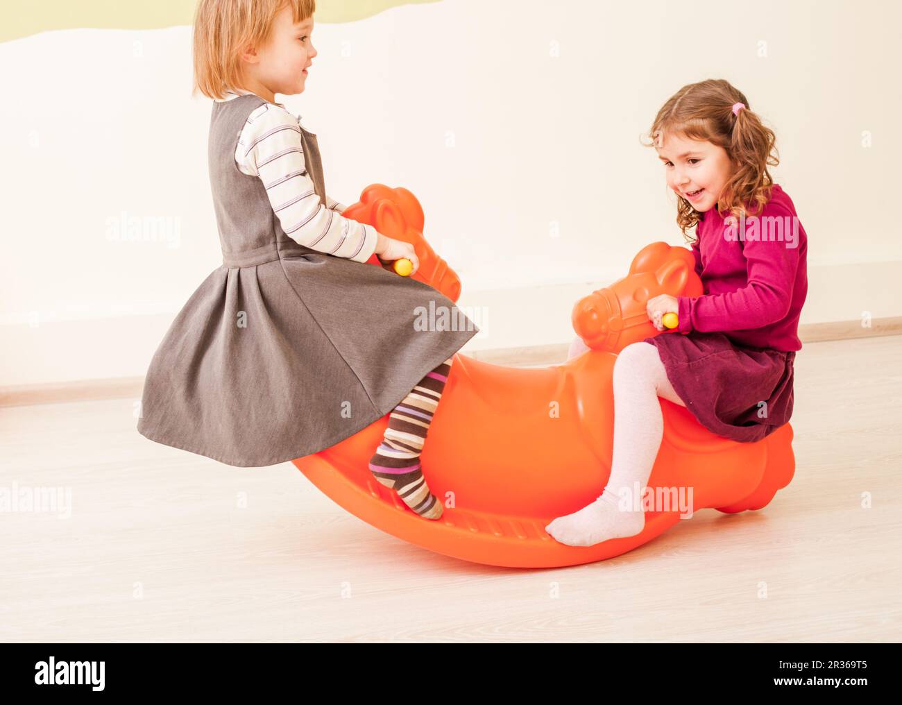 Children on the rocking seesaw Stock Photo - Alamy