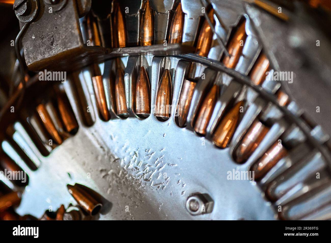 Pile of orange bullets and turning wheel at production line Stock Photo ...