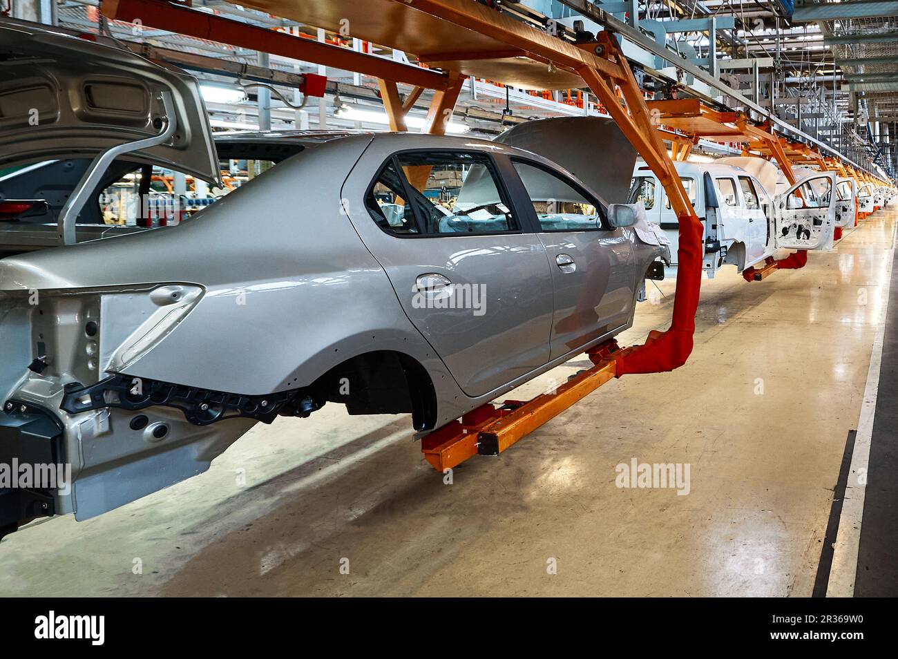 Car body transported by hanging conveyor in plant workshop Stock Photo ...
