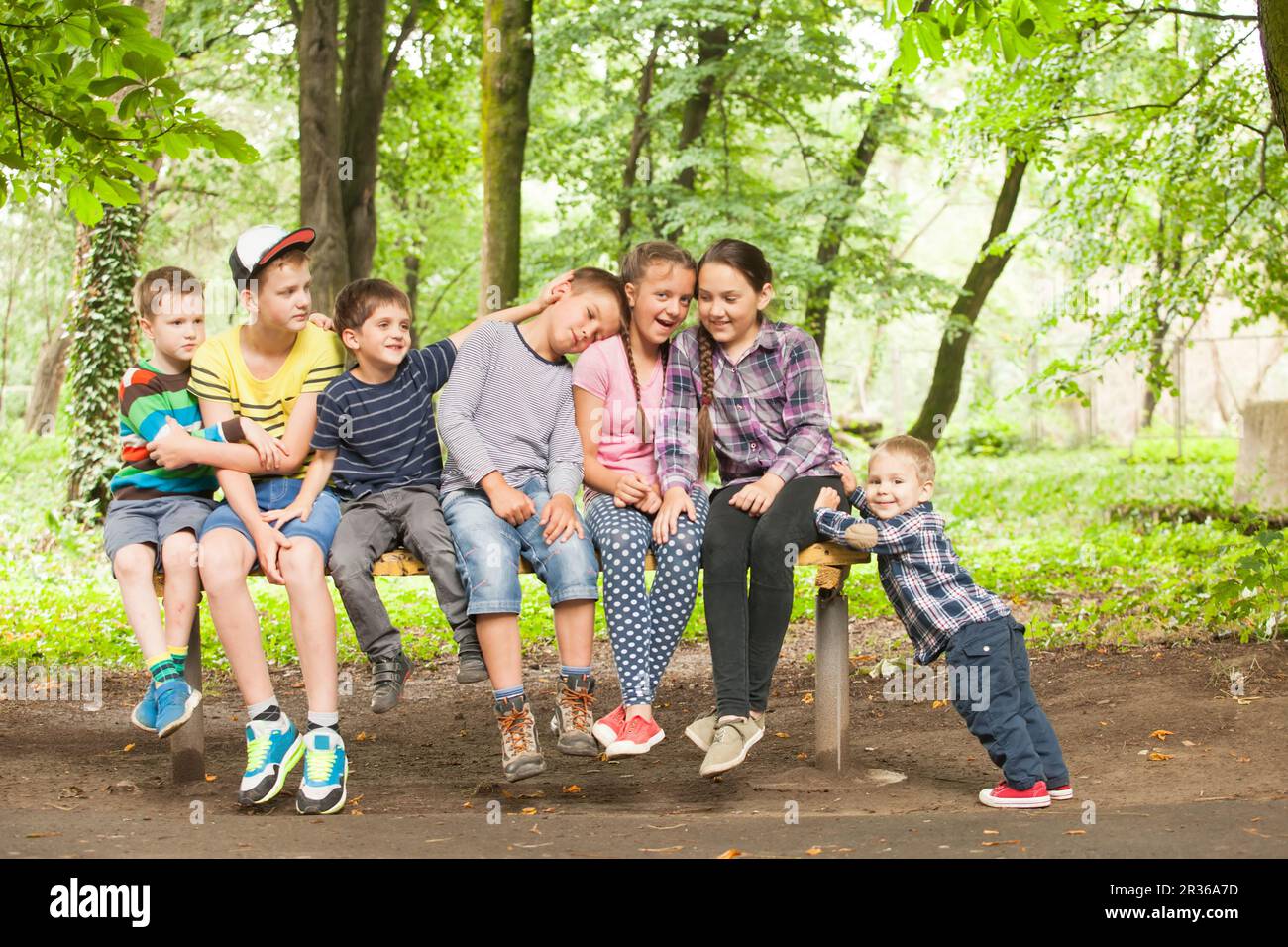 Kids on the bench Stock Photo - Alamy