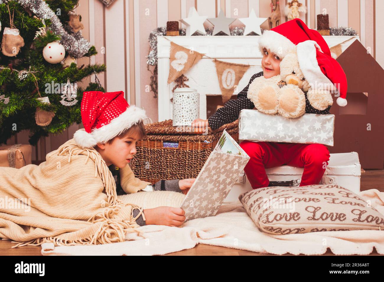 Two boys wearing Santa caps Stock Photo - Alamy