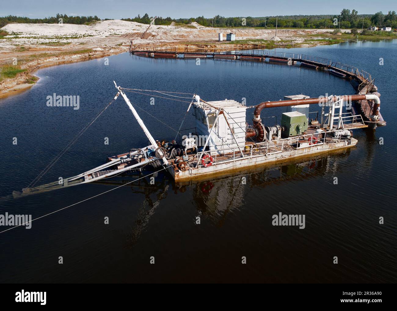 Trailing suction hopper dredger draws up bottom mud on river Stock ...
