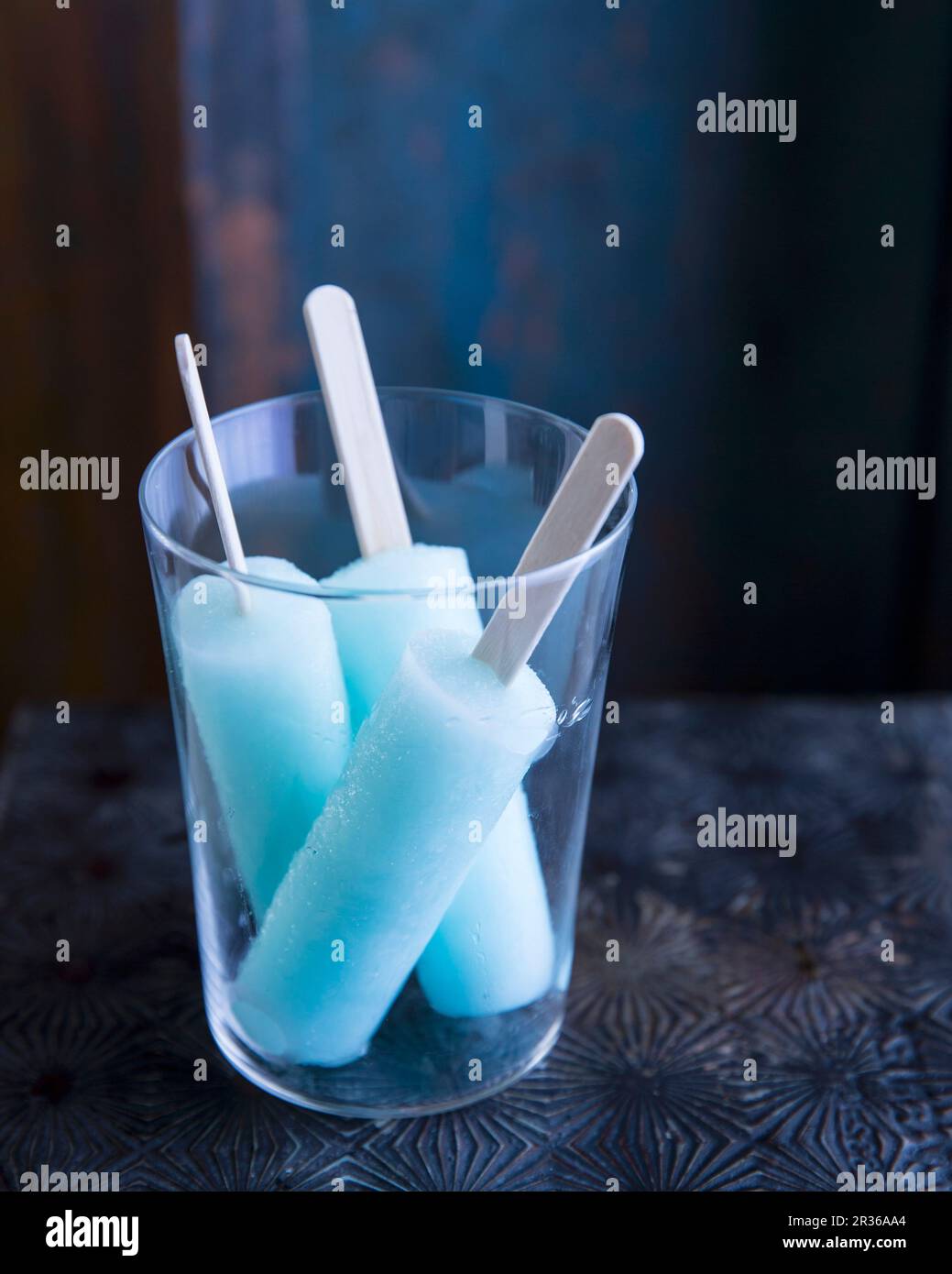 Three blue ice lollies in a glass Stock Photo - Alamy