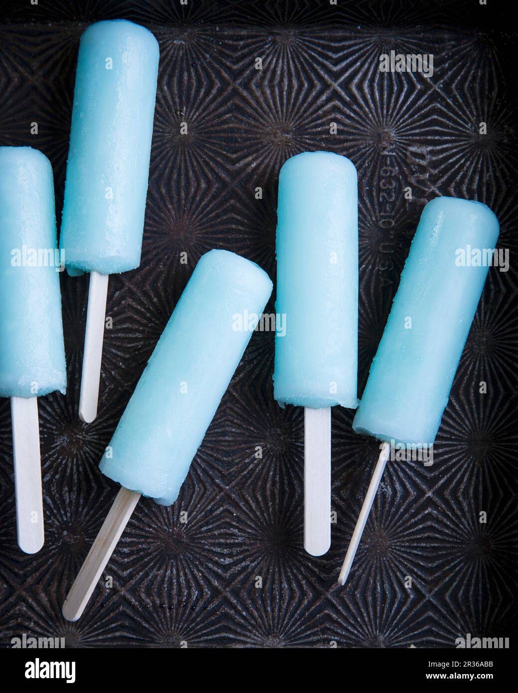 Blue ice lollies on a metal surface Stock Photo - Alamy