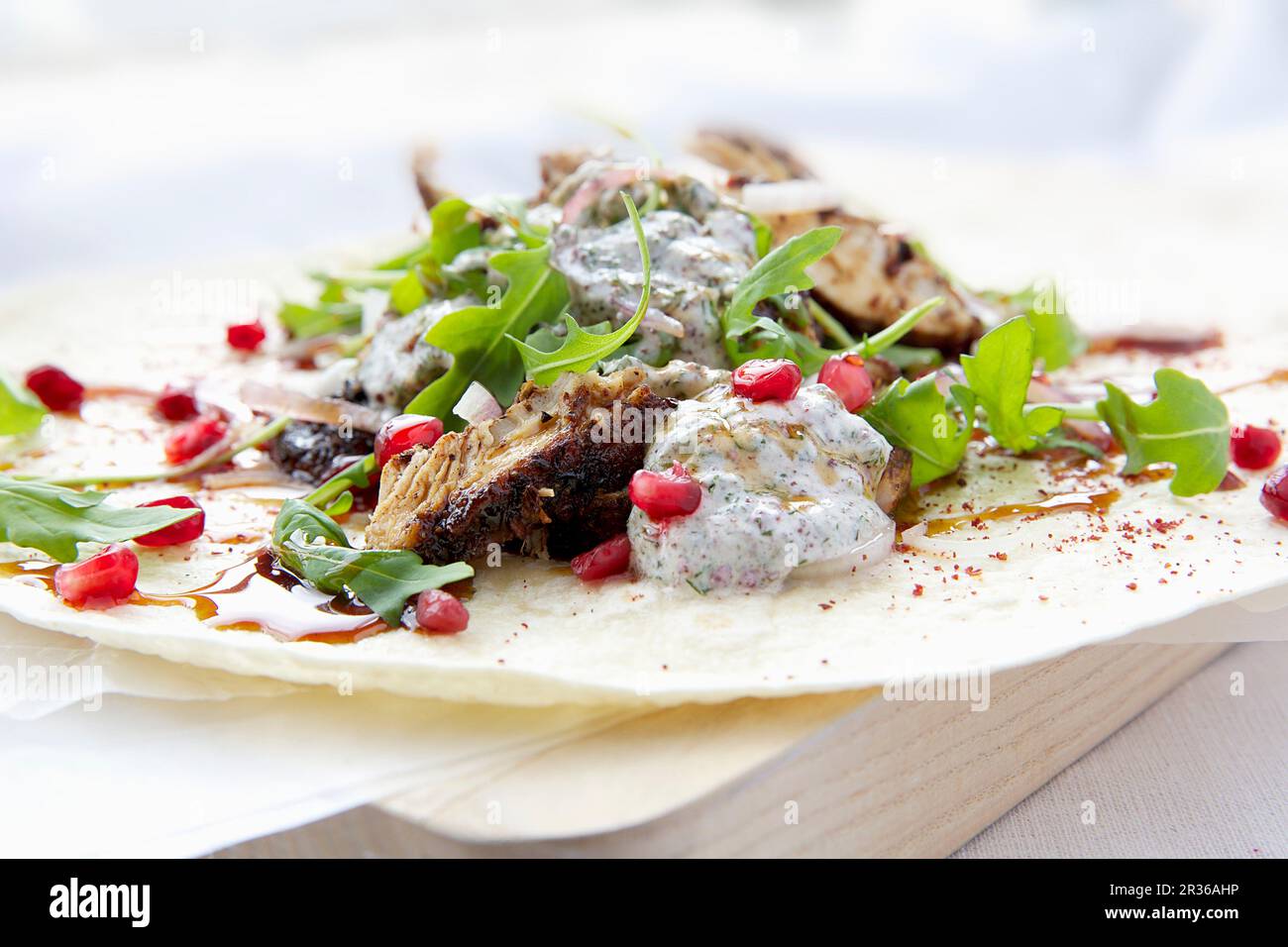 Persian chicken wraps with rocket and pomegranate Stock Photo - Alamy