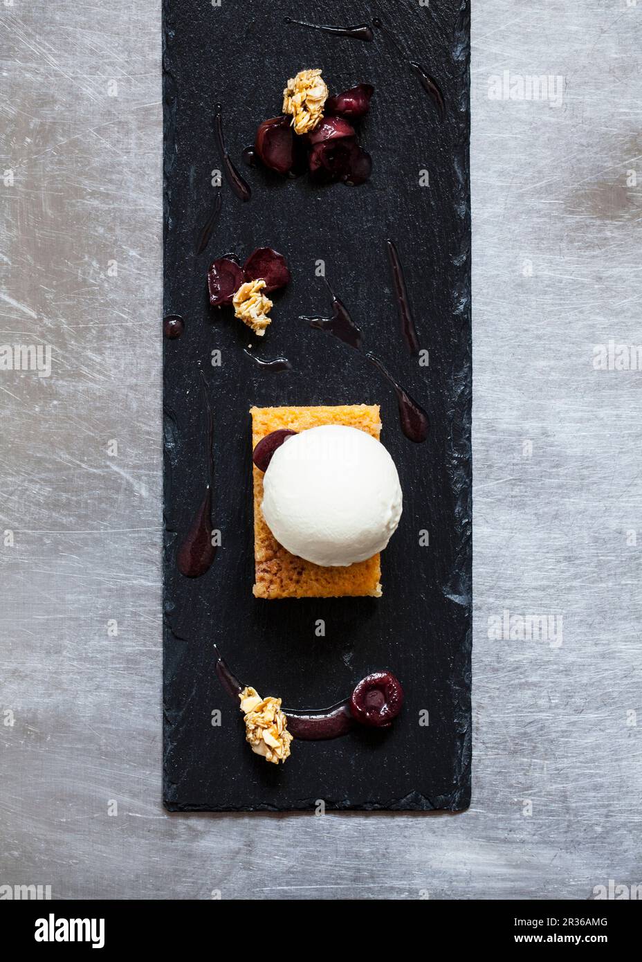 A ball of honey and rosemary parfait on a slice of carrot cake, halved ...