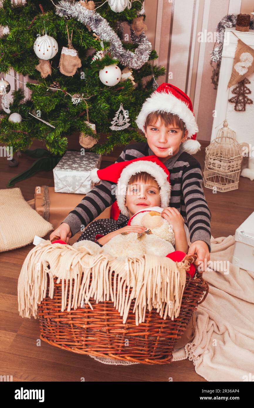 Two boys wearing Santa caps Stock Photo - Alamy