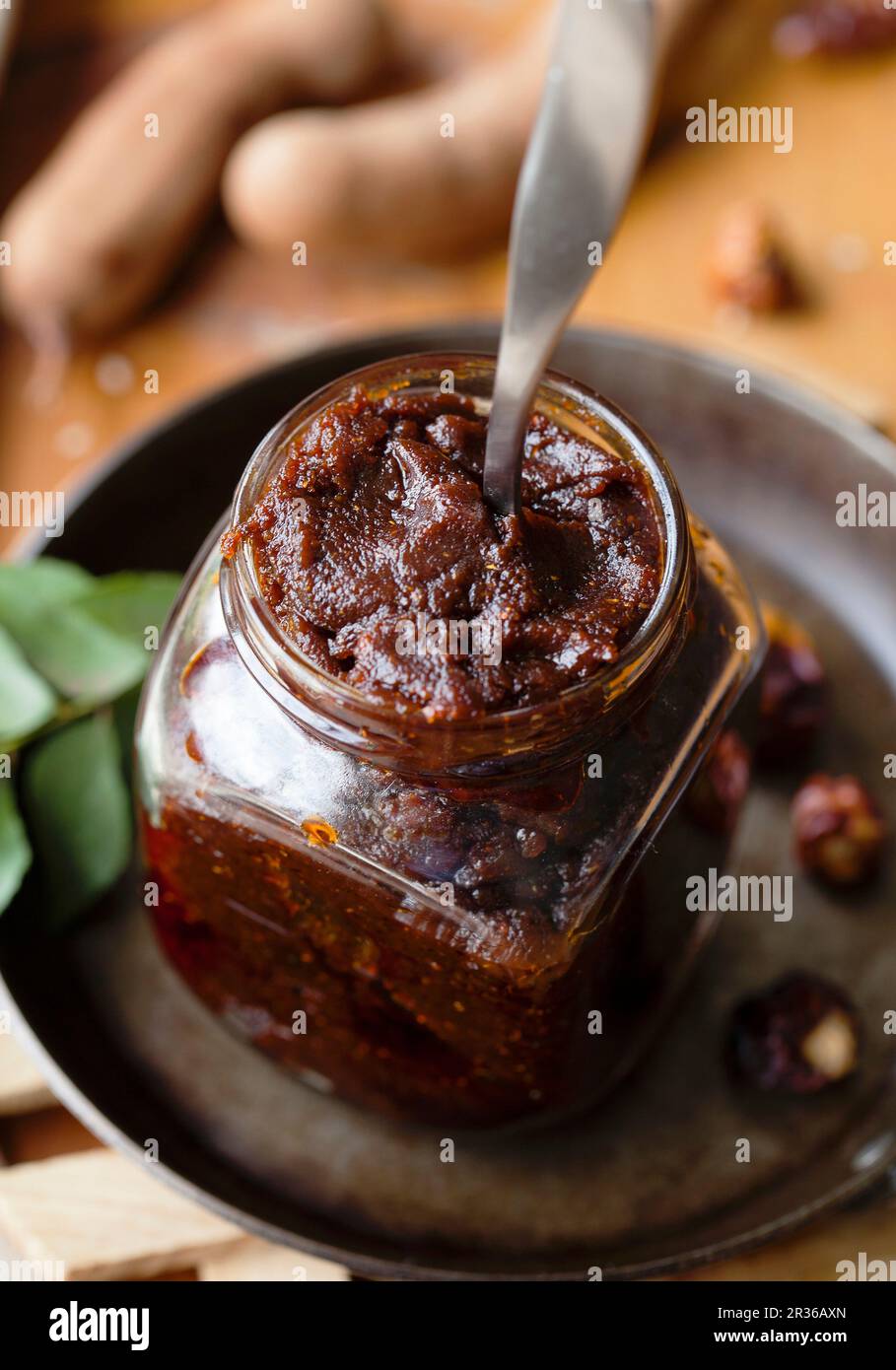 Tamarind chutney and a jar with a spoon Stock Photo - Alamy