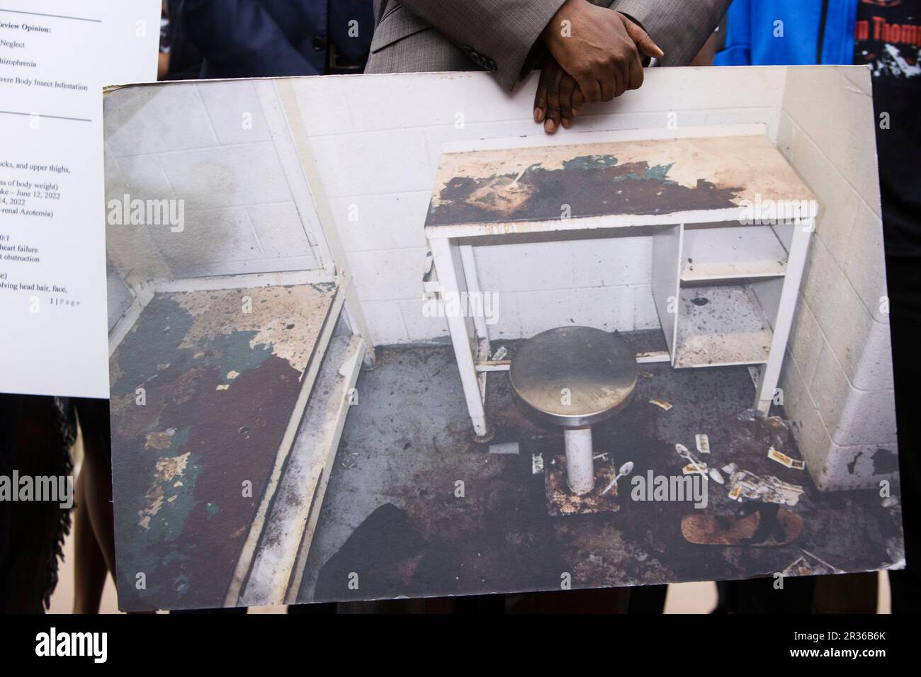 Attorney Michael Harper holds a photo of Lashawn Thompson's cell in the Fulton County Jail at a ...