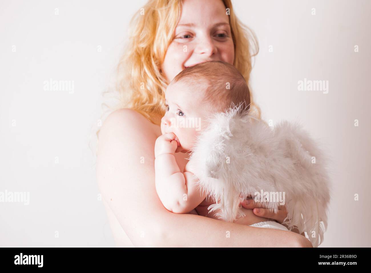 Portrait of mom with her baby angel Stock Photo - Alamy