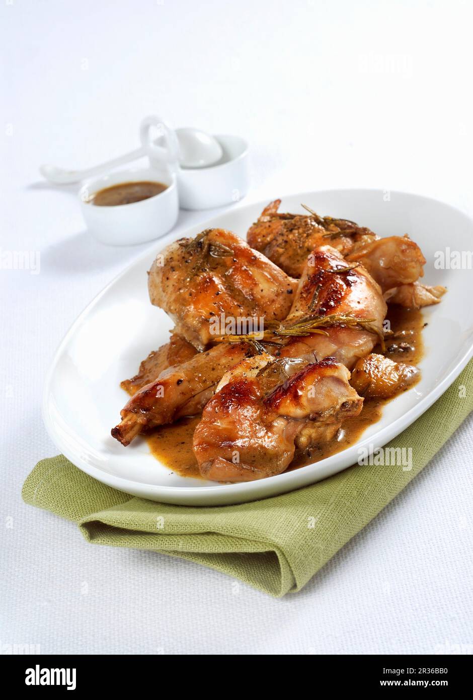 Braised rabbit in an anchovy and rosemary sauce Stock Photo - Alamy