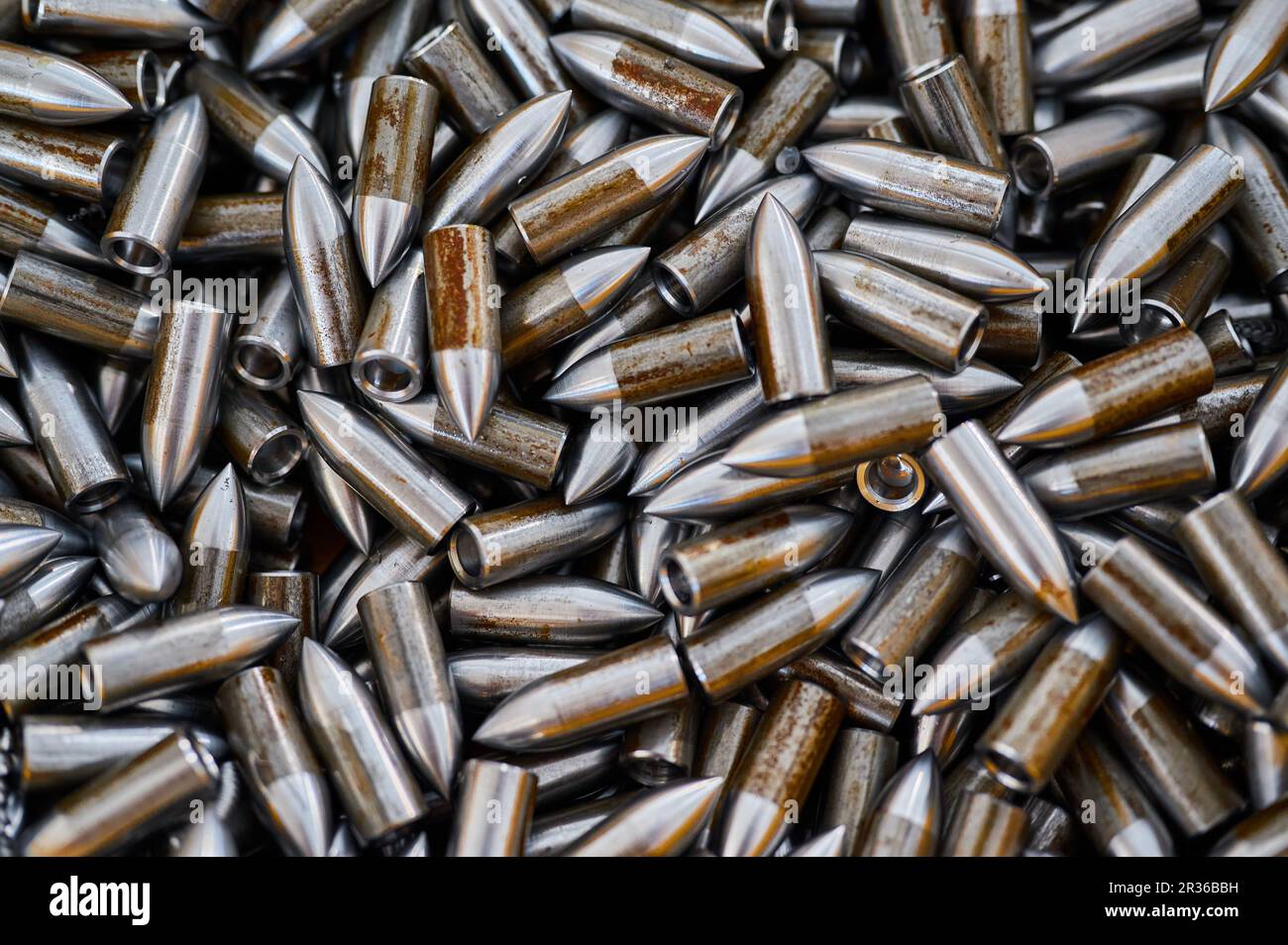 Scattered grey bullets armour ammunition as background Stock Photo - Alamy