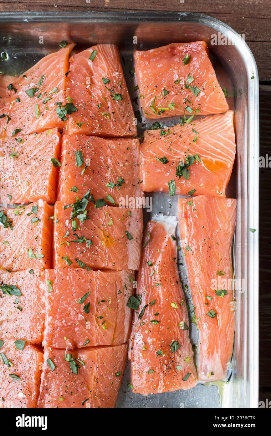 Raw salmon pieces in a roasting tin Stock Photo - Alamy