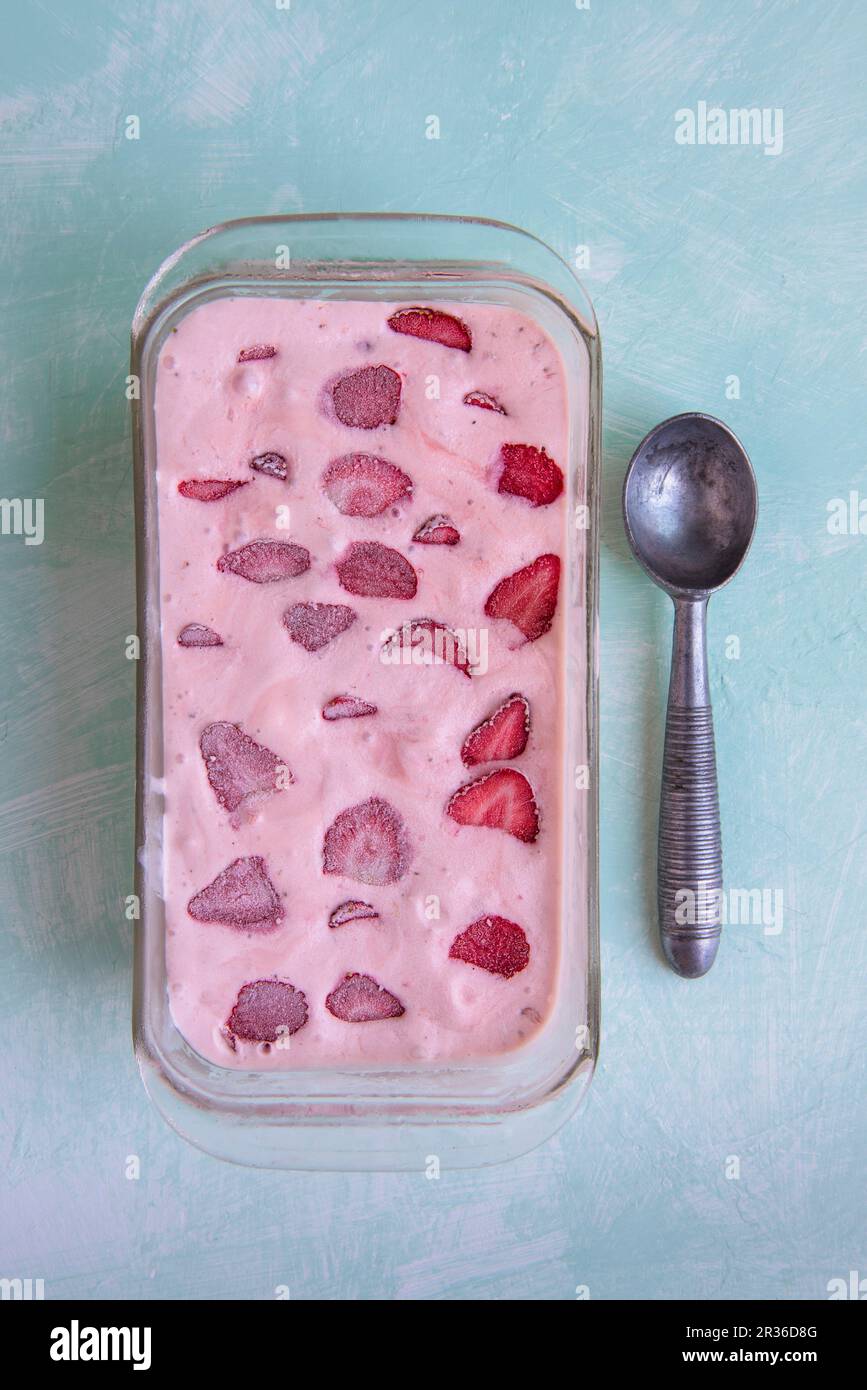 Homemade strawberry ice cream in a glass dish (seen above Stock Photo ...