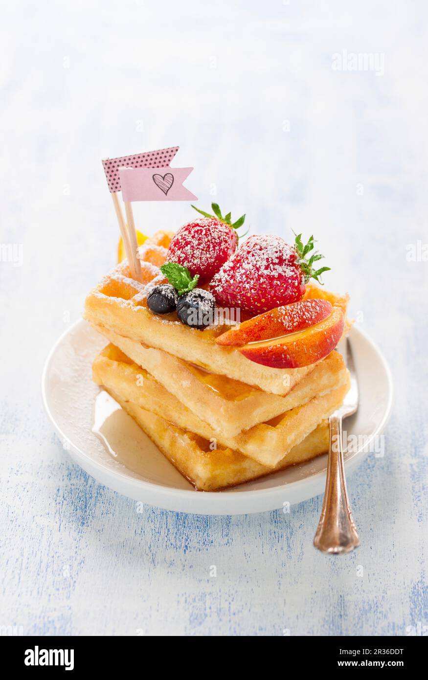 A stack of waffles with fresh fruit and agave syrup Stock Photo - Alamy