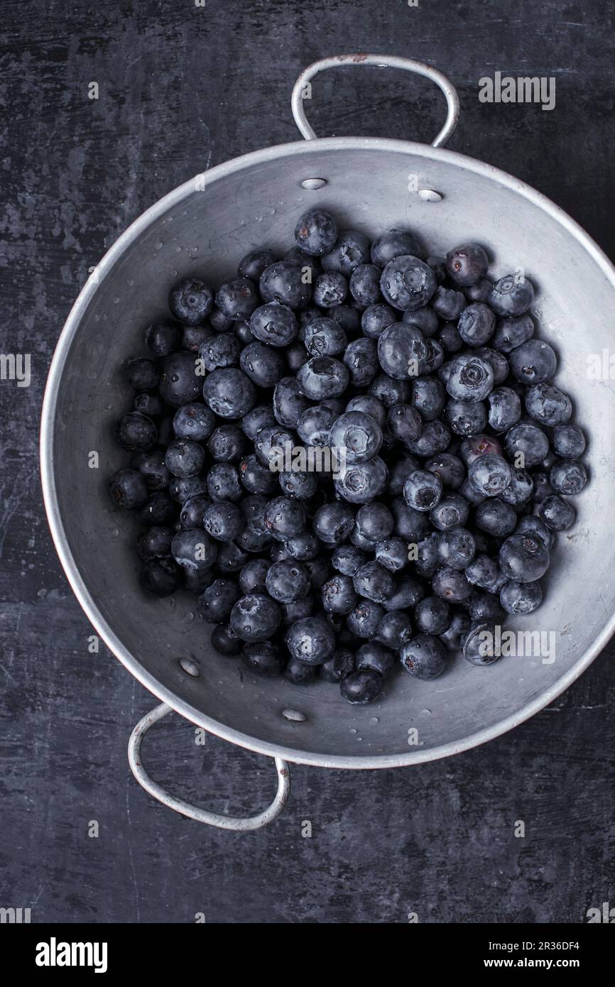 Fresh blueberries in colander hi-res stock photography and images - Alamy