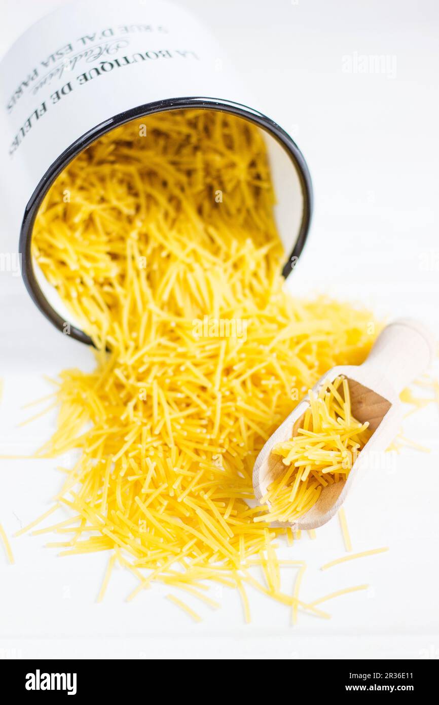 Angel hair pasta falling out of an overturned enamel bucket Stock Photo ...
