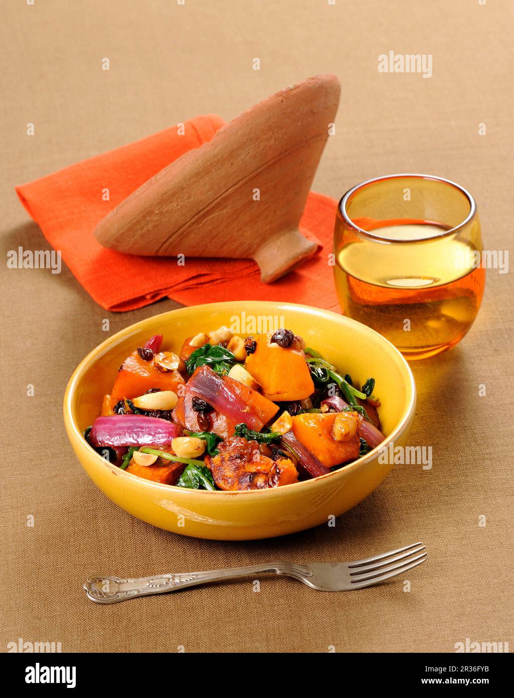 Braised pumpkin with spinach, onions, raisins and hazelnuts Stock Photo ...