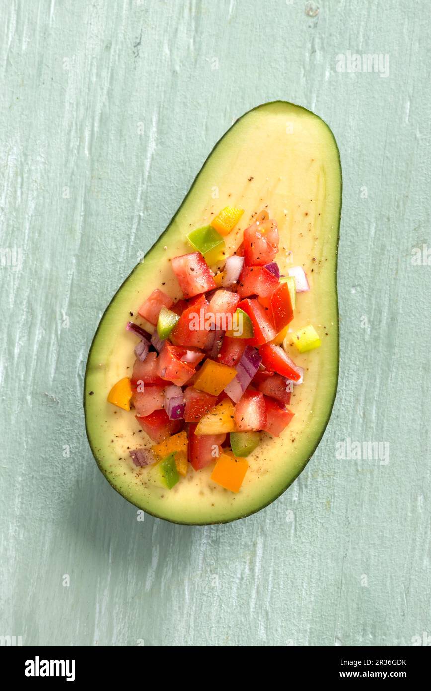 Avocado filled with vegetables Stock Photo - Alamy