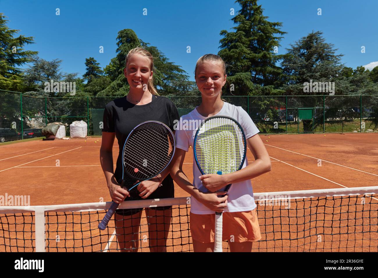 Tennis players standing together on the tennis court, poised and ...