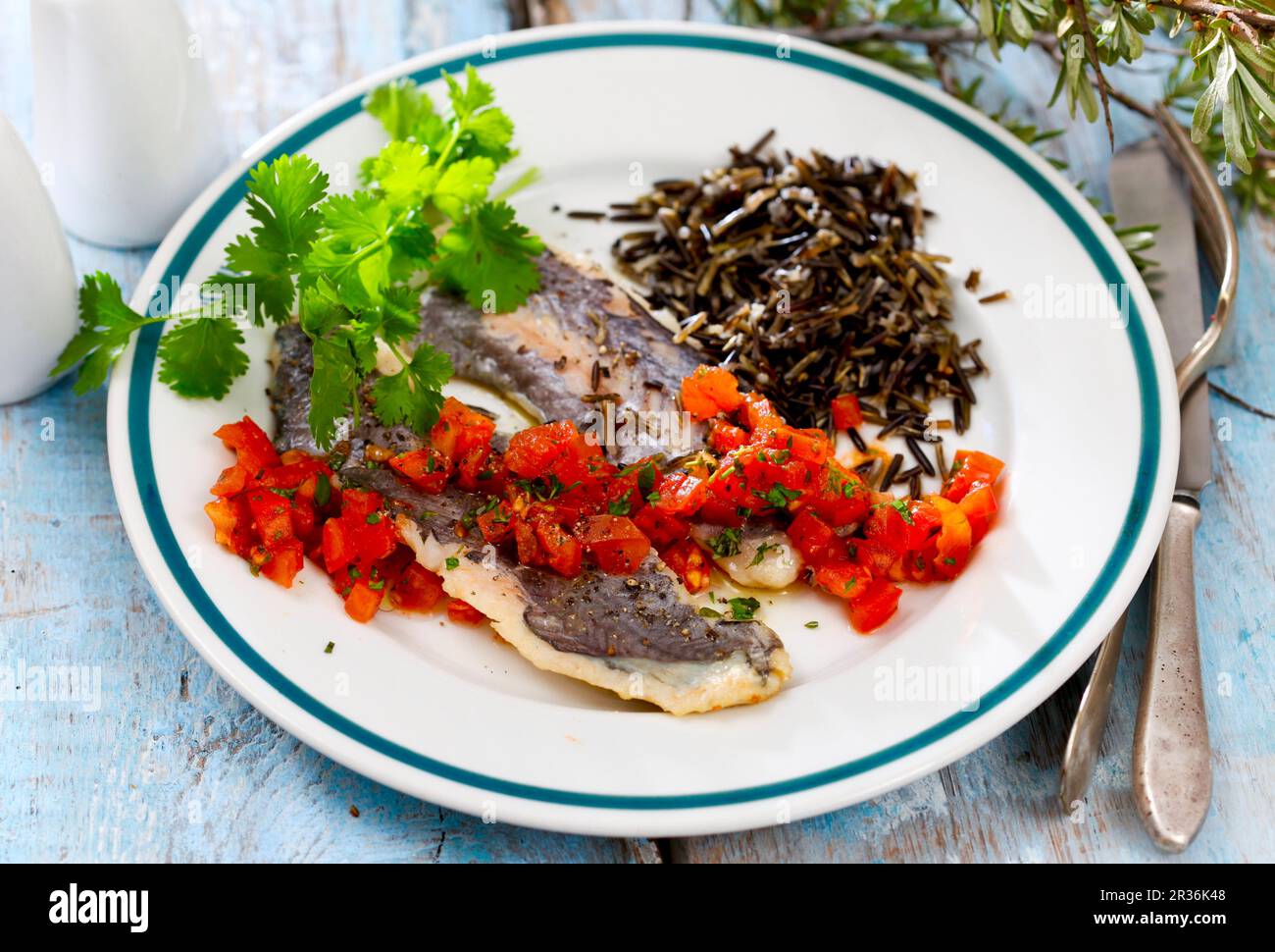 Hake fillets with a pepper salsa and wild rice Stock Photo - Alamy