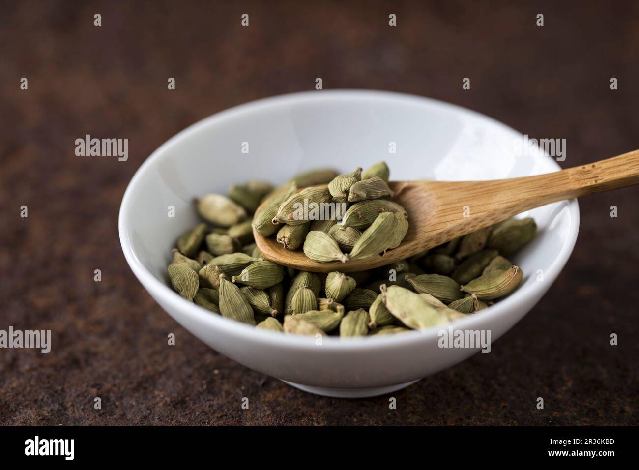 Cardamom in a small dish Stock Photo - Alamy