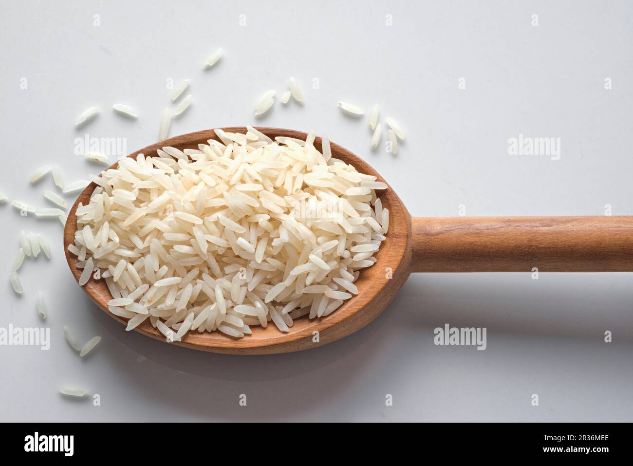 Basmati rice on an olive wood spoon Stock Photo - Alamy
