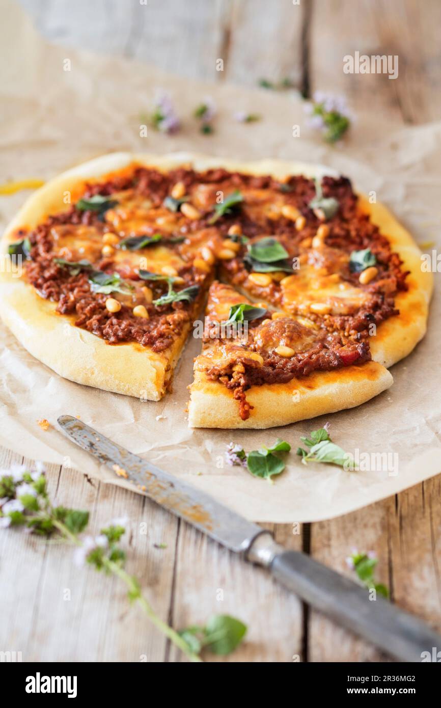 Minced meat pizza, sliced Stock Photo - Alamy