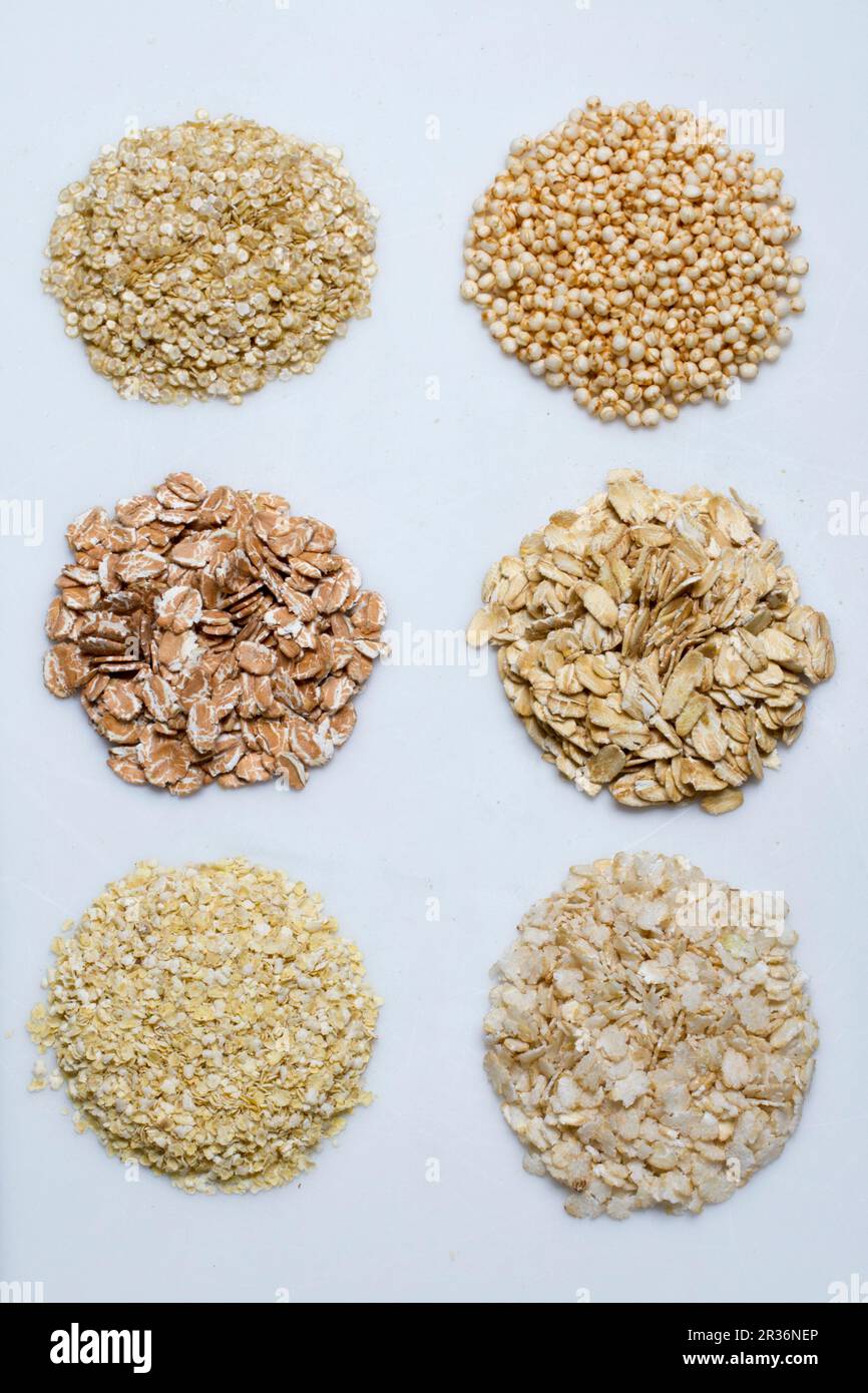 Six piles of various grains on a white surface Stock Photo - Alamy