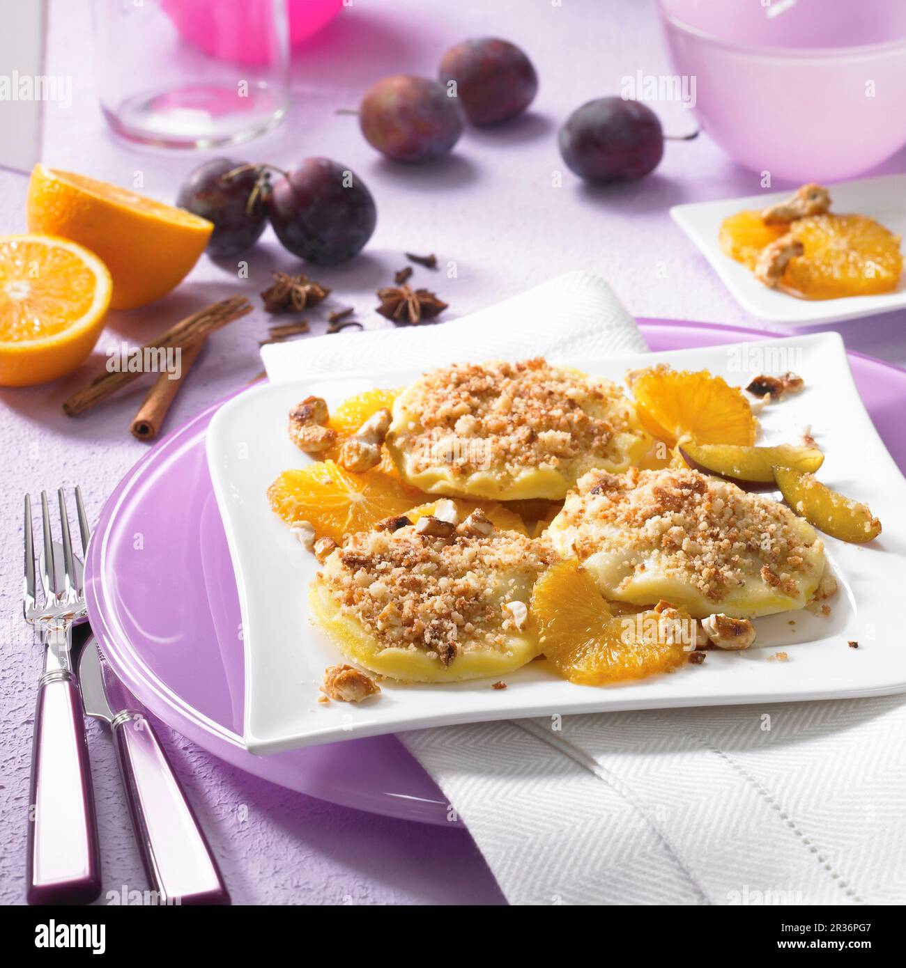 Powidltaschen (stewed plum pastries) with oranges, plums and nuts Stock ...