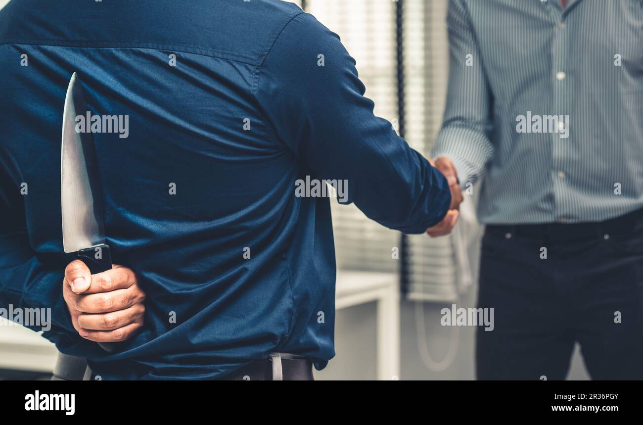Businessman holding knife behind back hi-res stock photography and ...