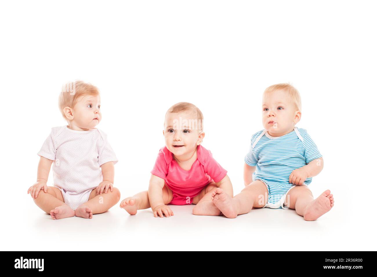 Three babies sitting Stock Photo - Alamy