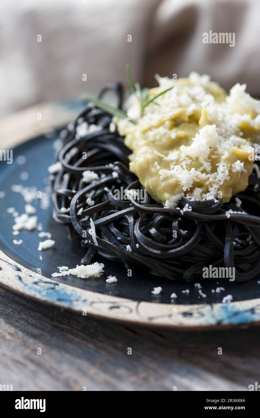 Black squid ink pasta with avocado pesto and Parmesan Stock Photo - Alamy