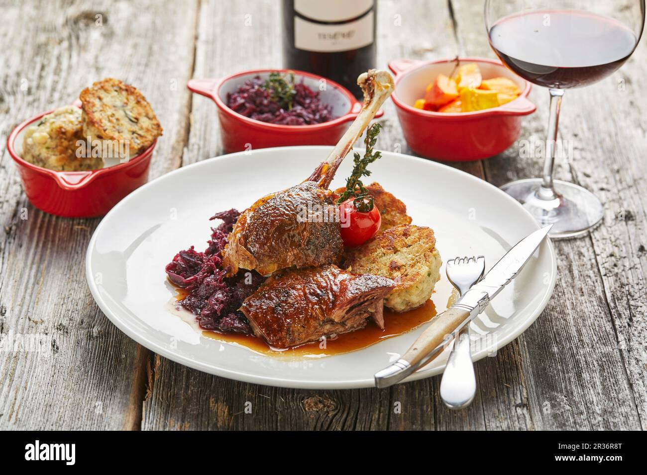 Roast goose with bread dumplings, red cabbage, pumpkin and a glass of ...