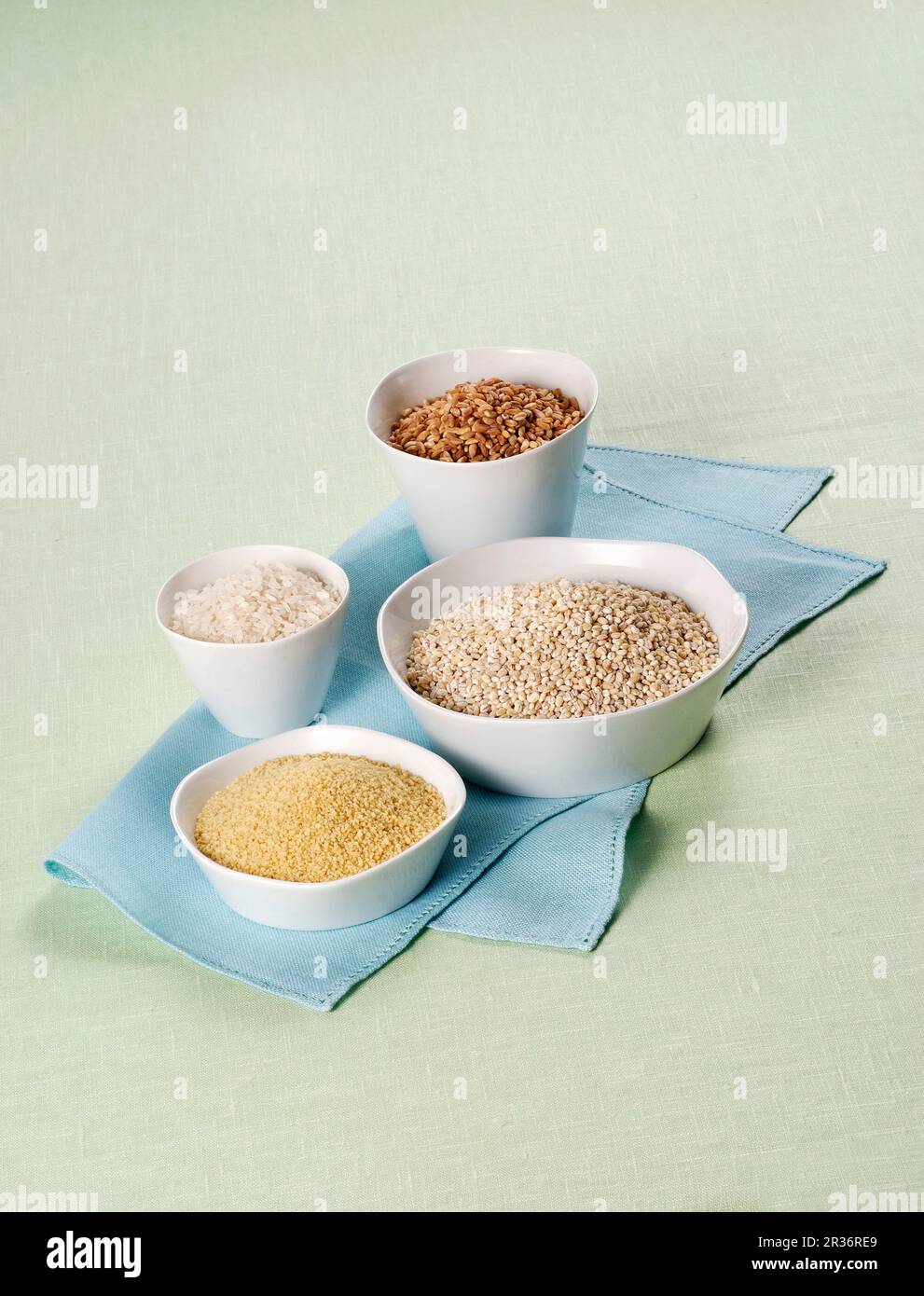 Rice, spelt, barley and couscous in white bowls Stock Photo - Alamy