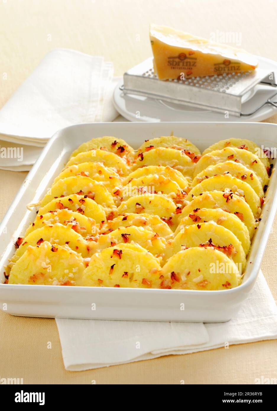 Baked semolina slices with bacon and Sbrinz cheese Stock Photo - Alamy