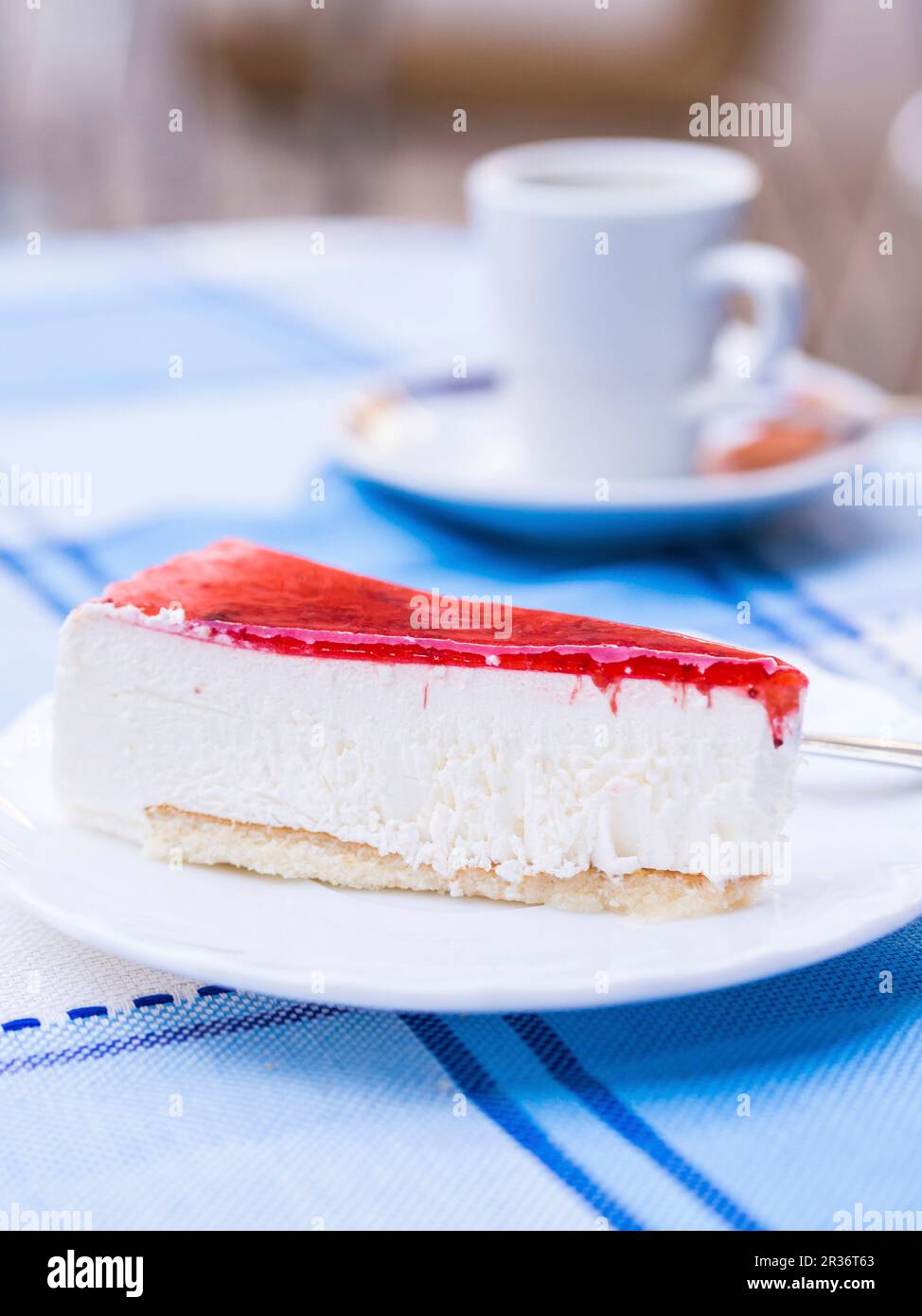A slice of cold cheesecake with a strawberry topping Stock Photo - Alamy
