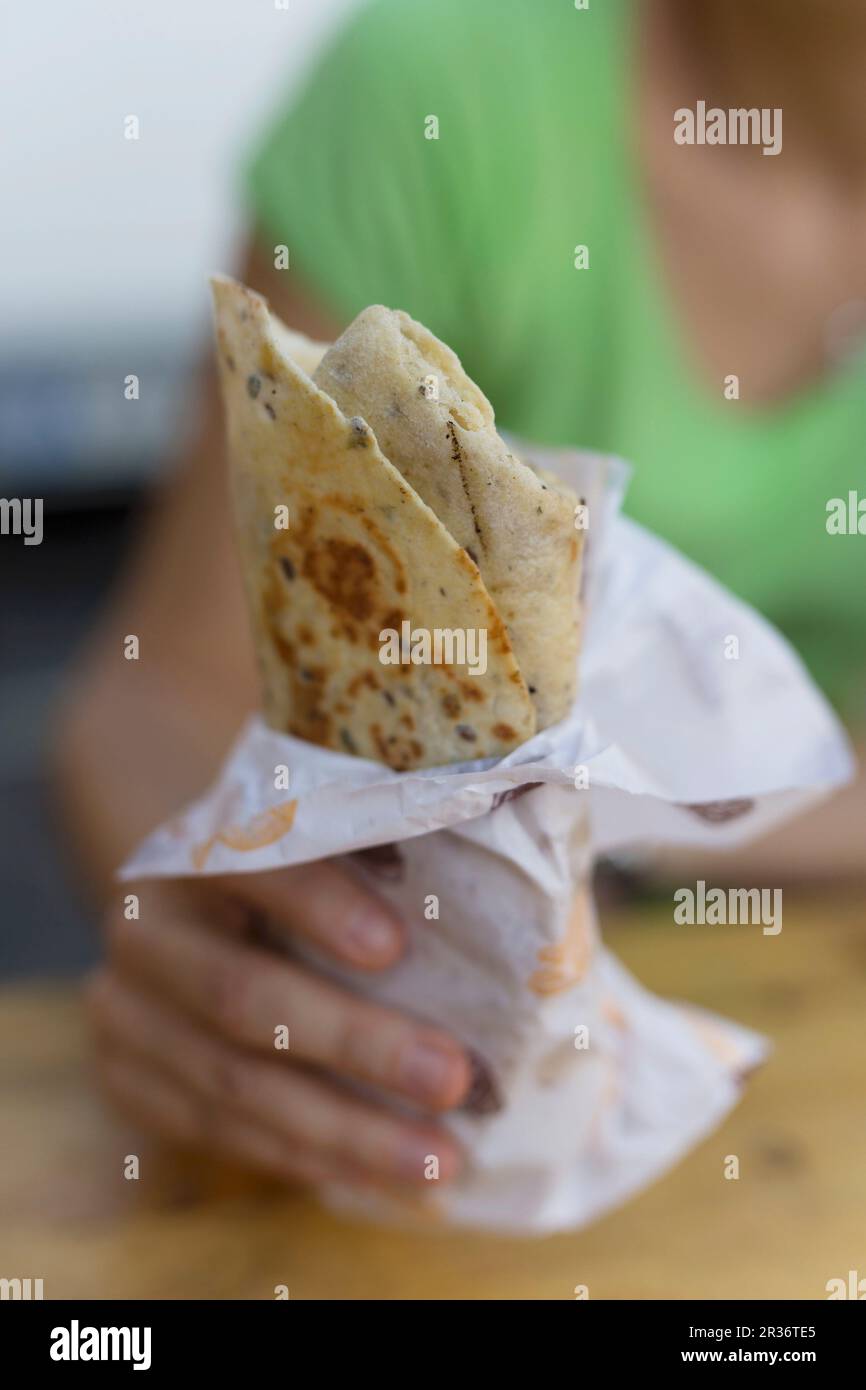 A hand holding a wrap Stock Photo - Alamy