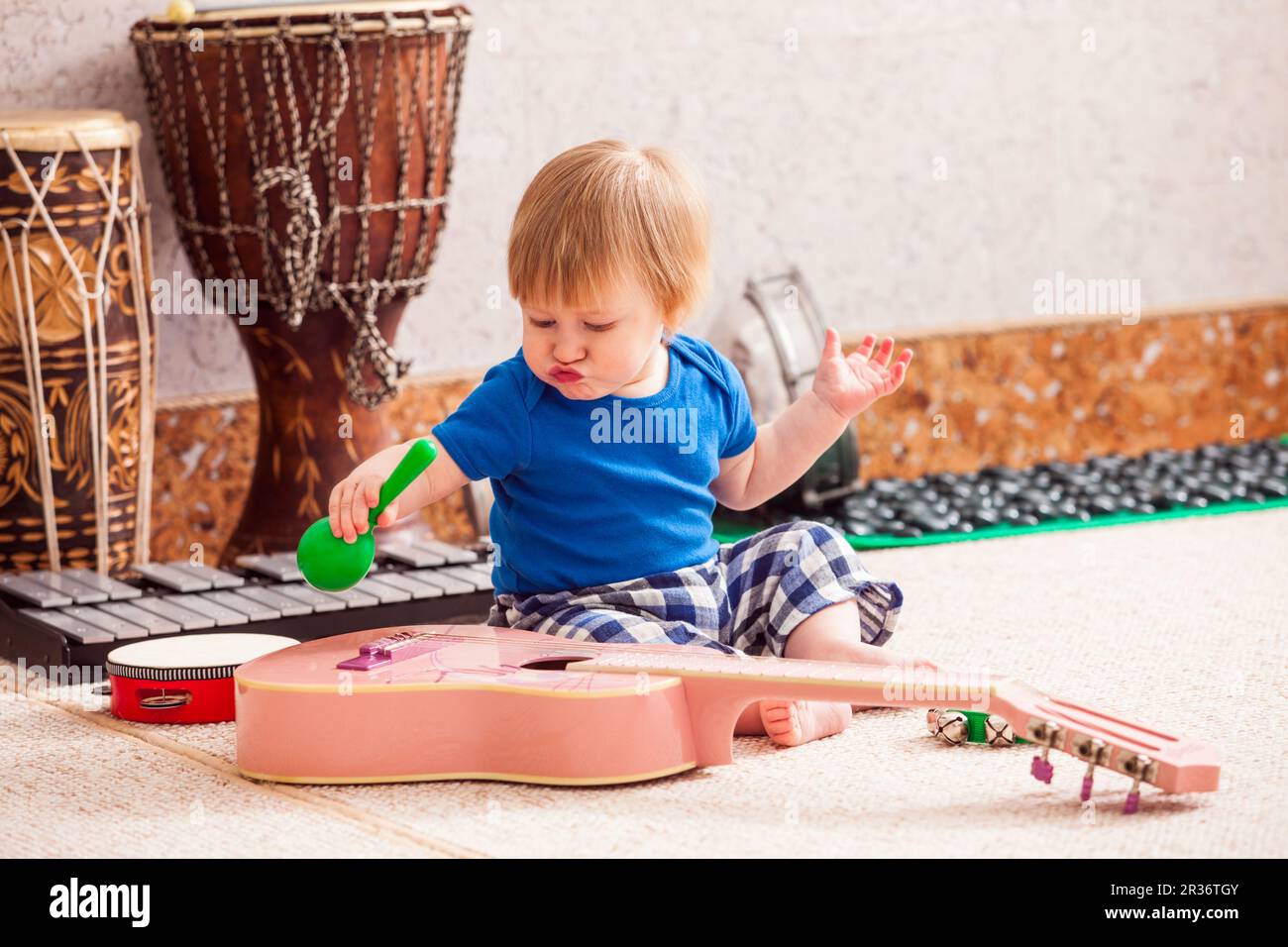 Boy with musical instruments Stock Photo - Alamy