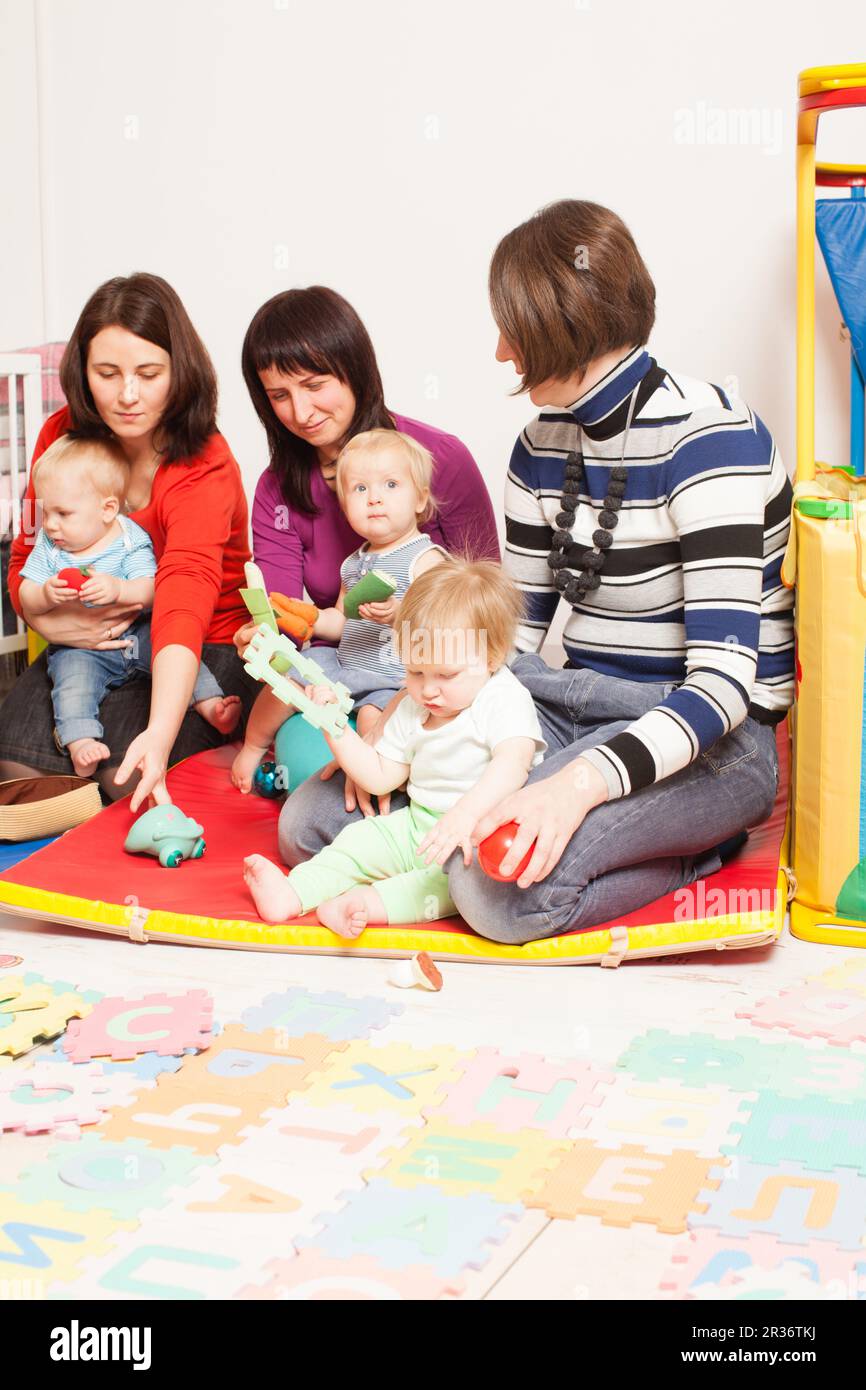 Group of mothers with their babies Stock Photo - Alamy