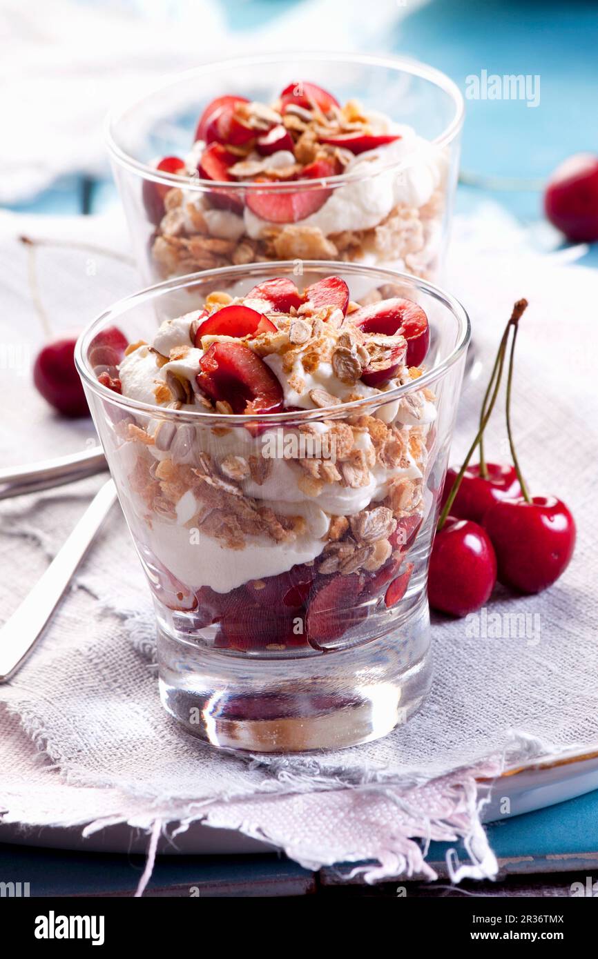 Cherry desserts with yoghurt and flakes Stock Photo - Alamy