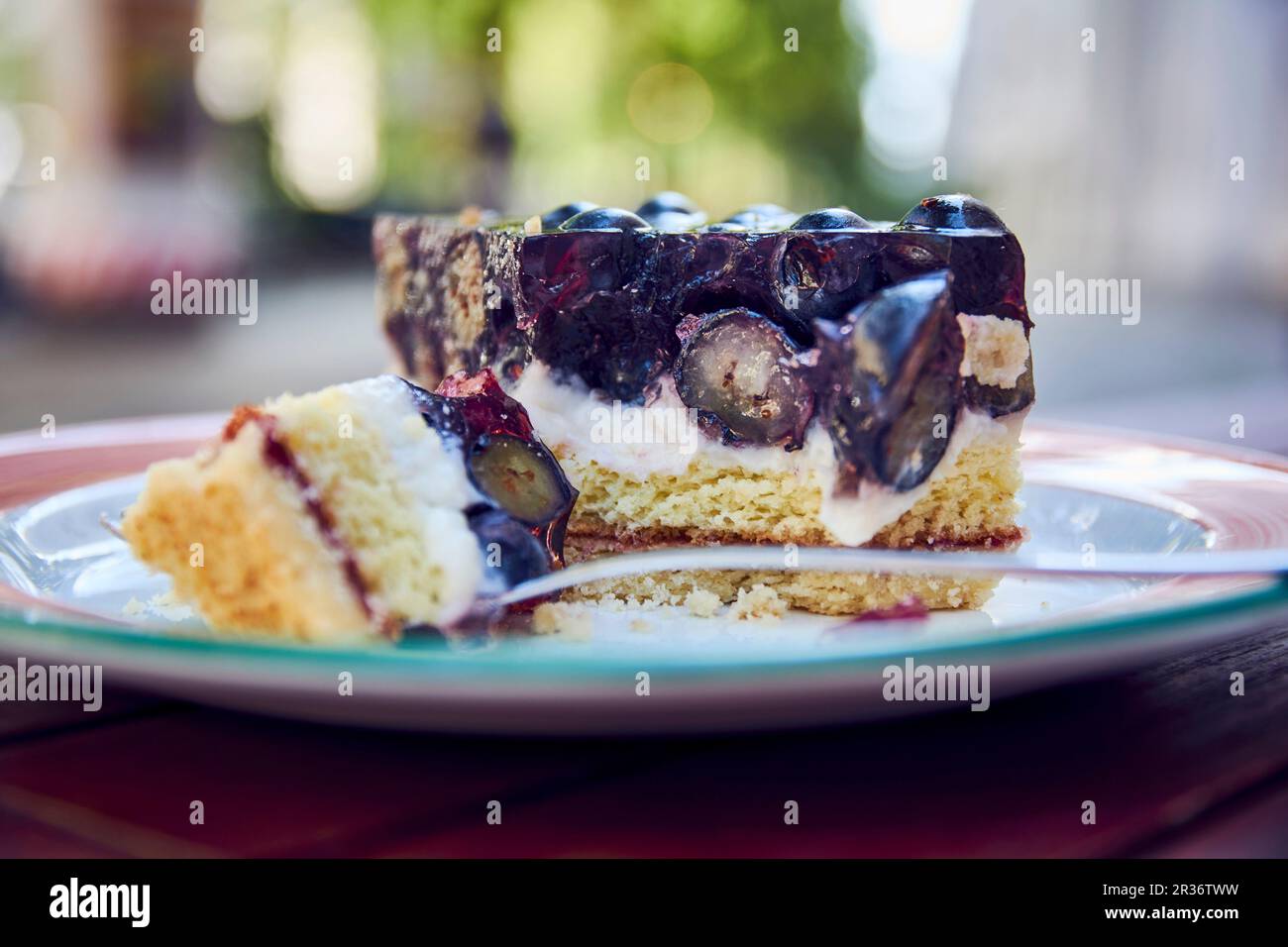 Blueberry cake with a bite taken Stock Photo - Alamy