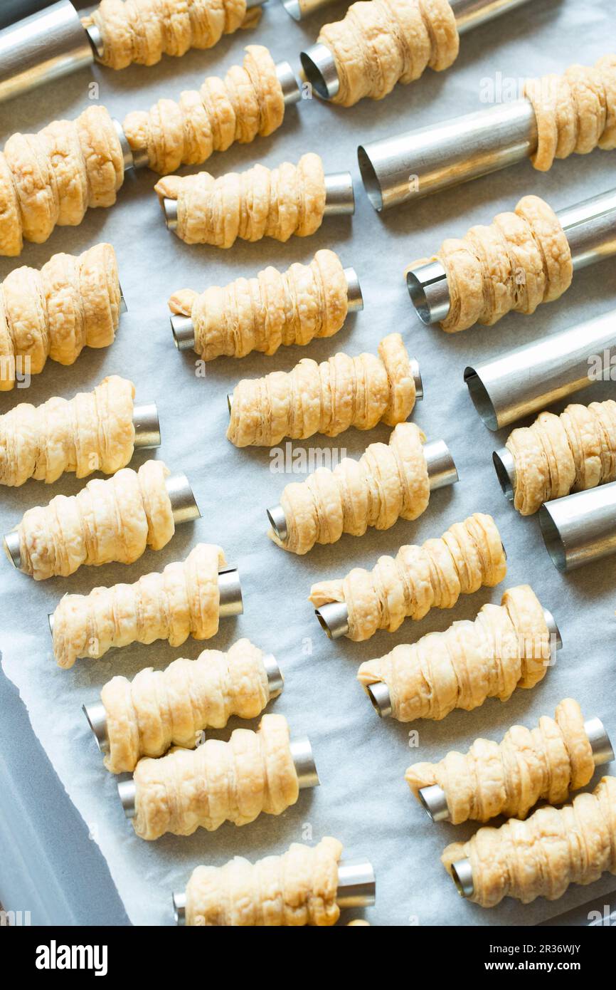Freshly baked puff pastry rolls to be filled with cream Stock Photo - Alamy