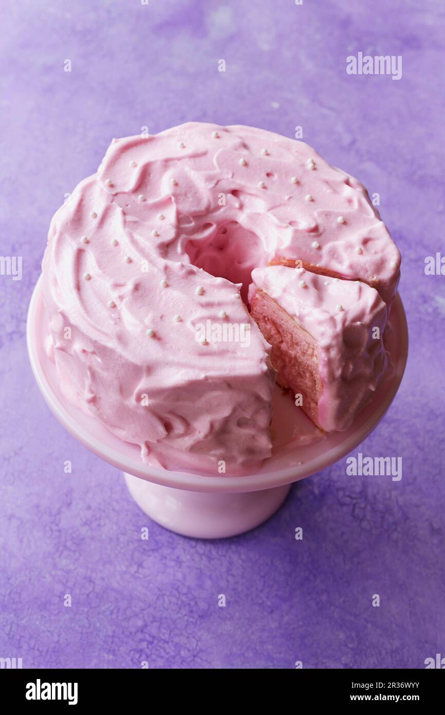 A sliced pink angel cake on a cake stand Stock Photo - Alamy