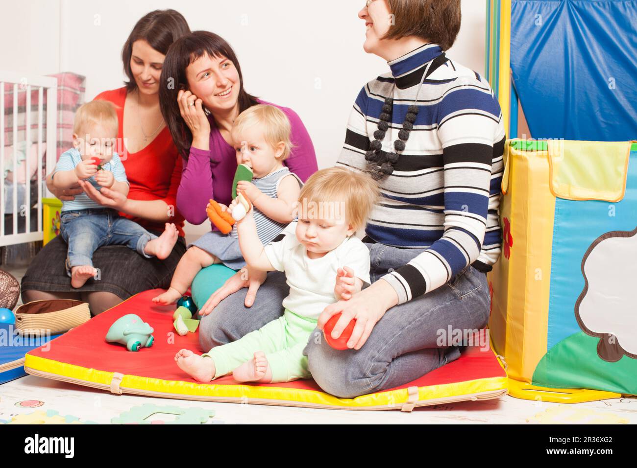 Group of mothers with their babies Stock Photo - Alamy
