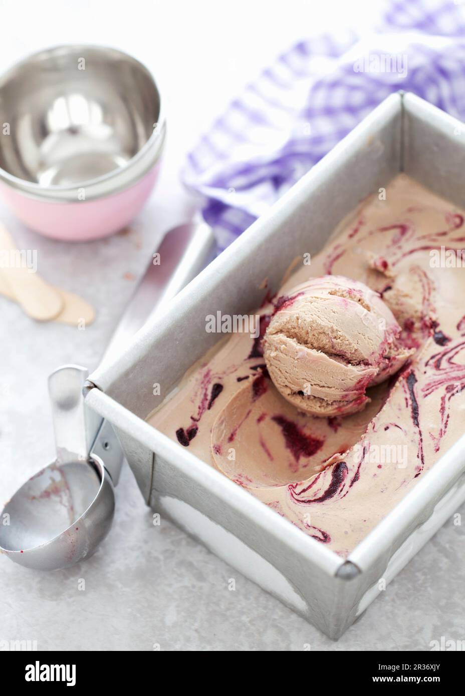 An ice cream tub with milk chocolate and blackberry ripple ice cream ...