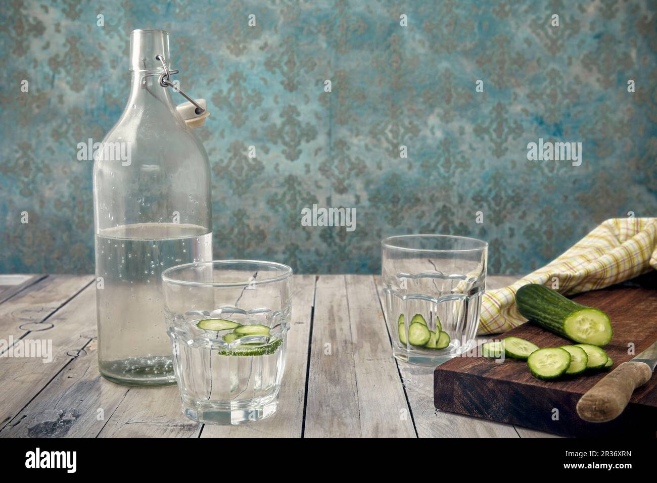 A glass of cucumber water, a bottle of water and fresh cucumber Stock ...