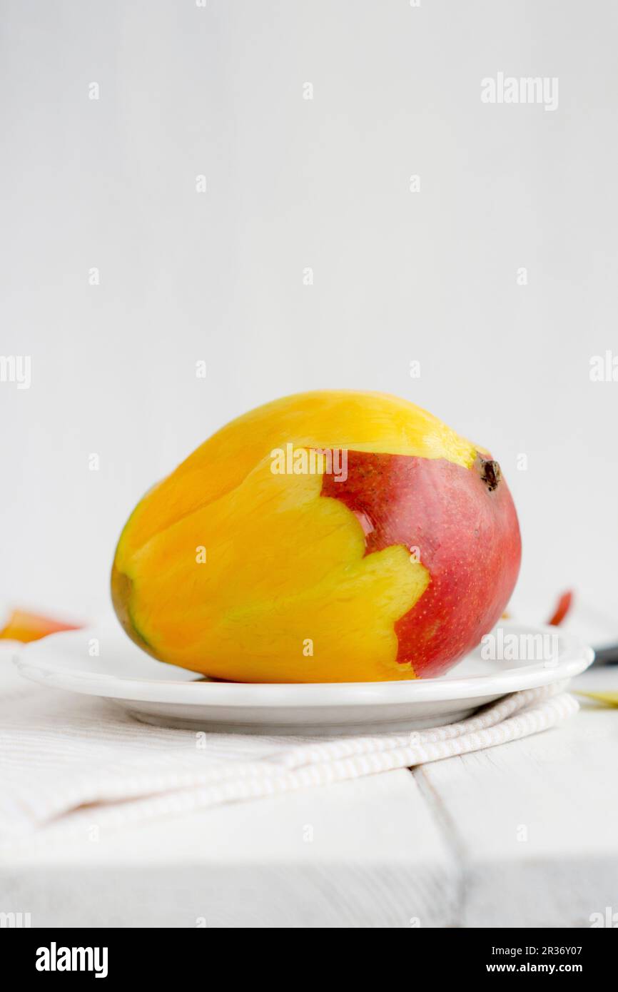 A peeled mango on a plate Stock Photo - Alamy